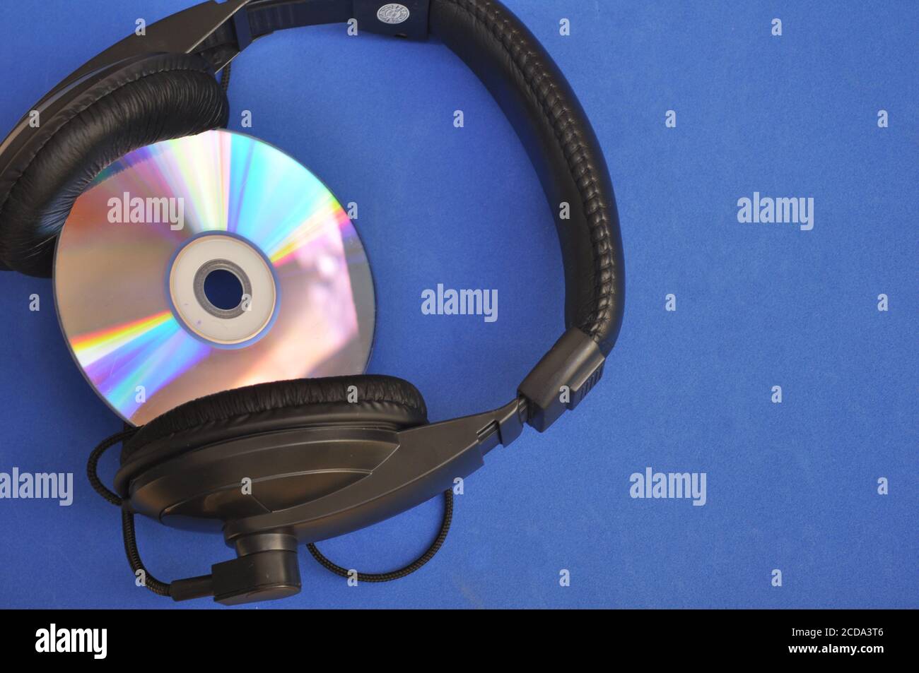 Compact disc and headphone on blue background with top view Stock Photo ...