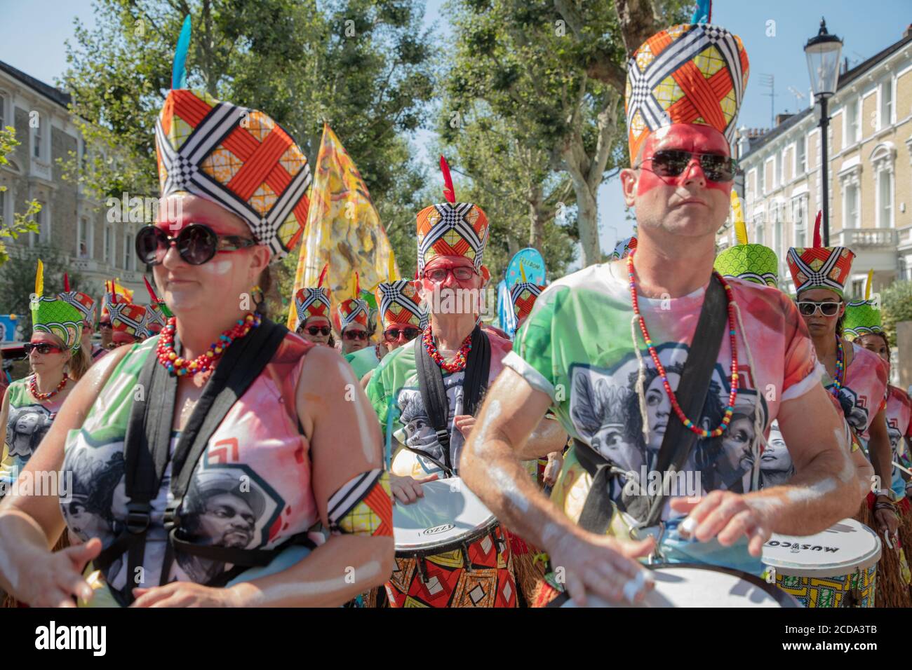 Group of musicians in colorful costumes seen with hand drums at the ...
