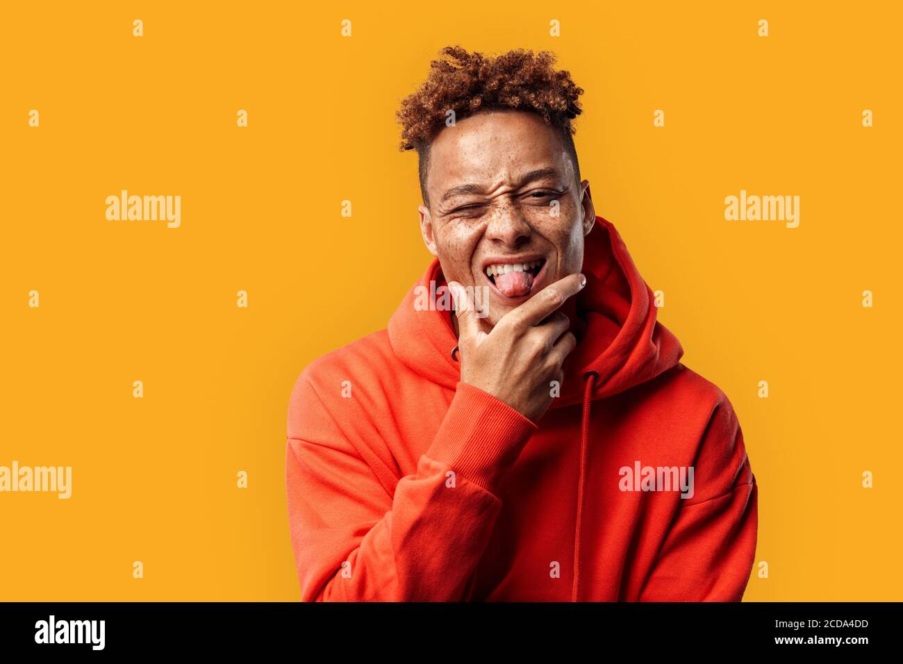 Young adult millennial showing tongue out, making grimace Stock Photo ...