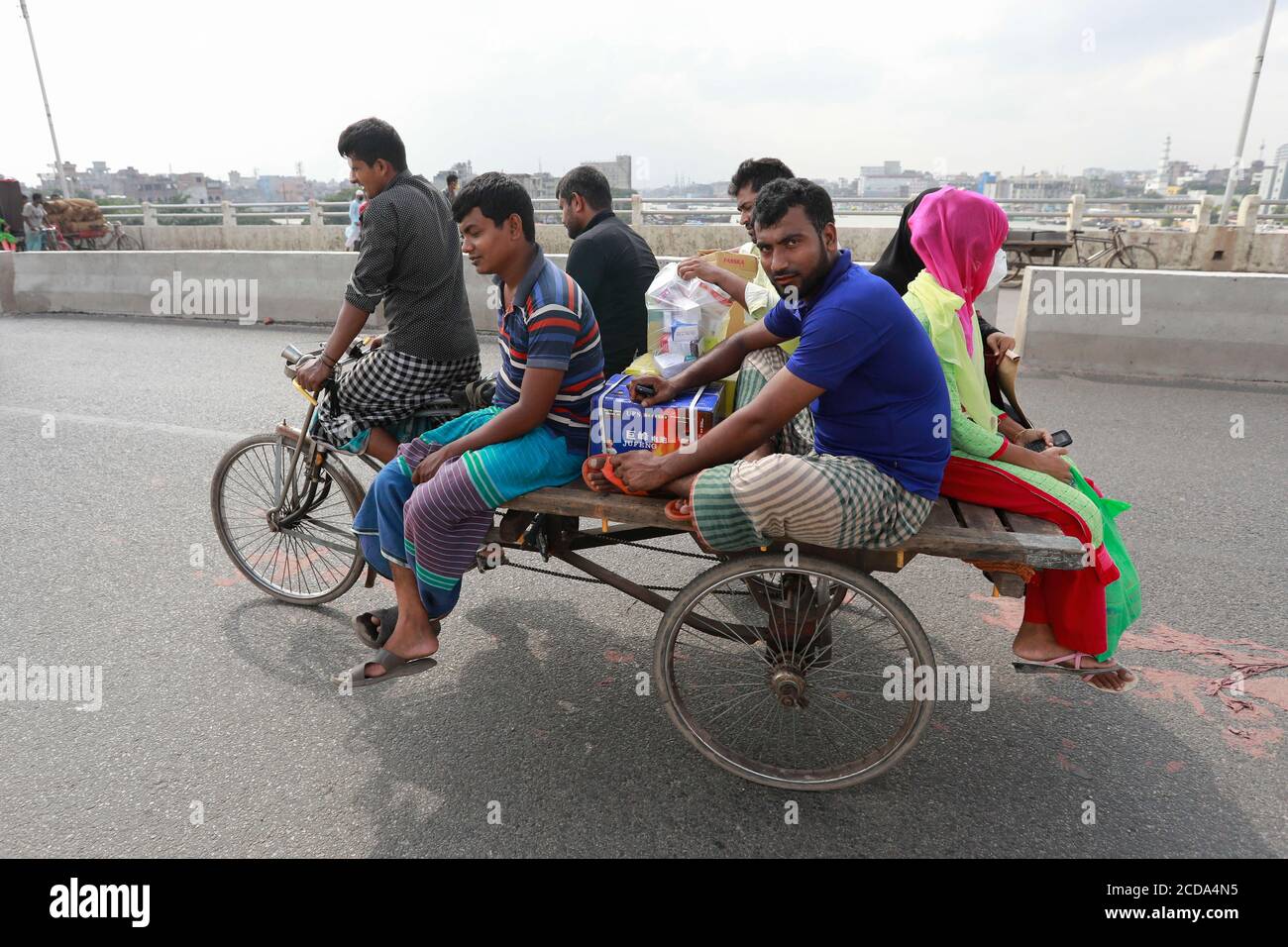Dhaka, Bangladesh. 27th Aug, 2020. Bangladeshi people take a ride on a ...
