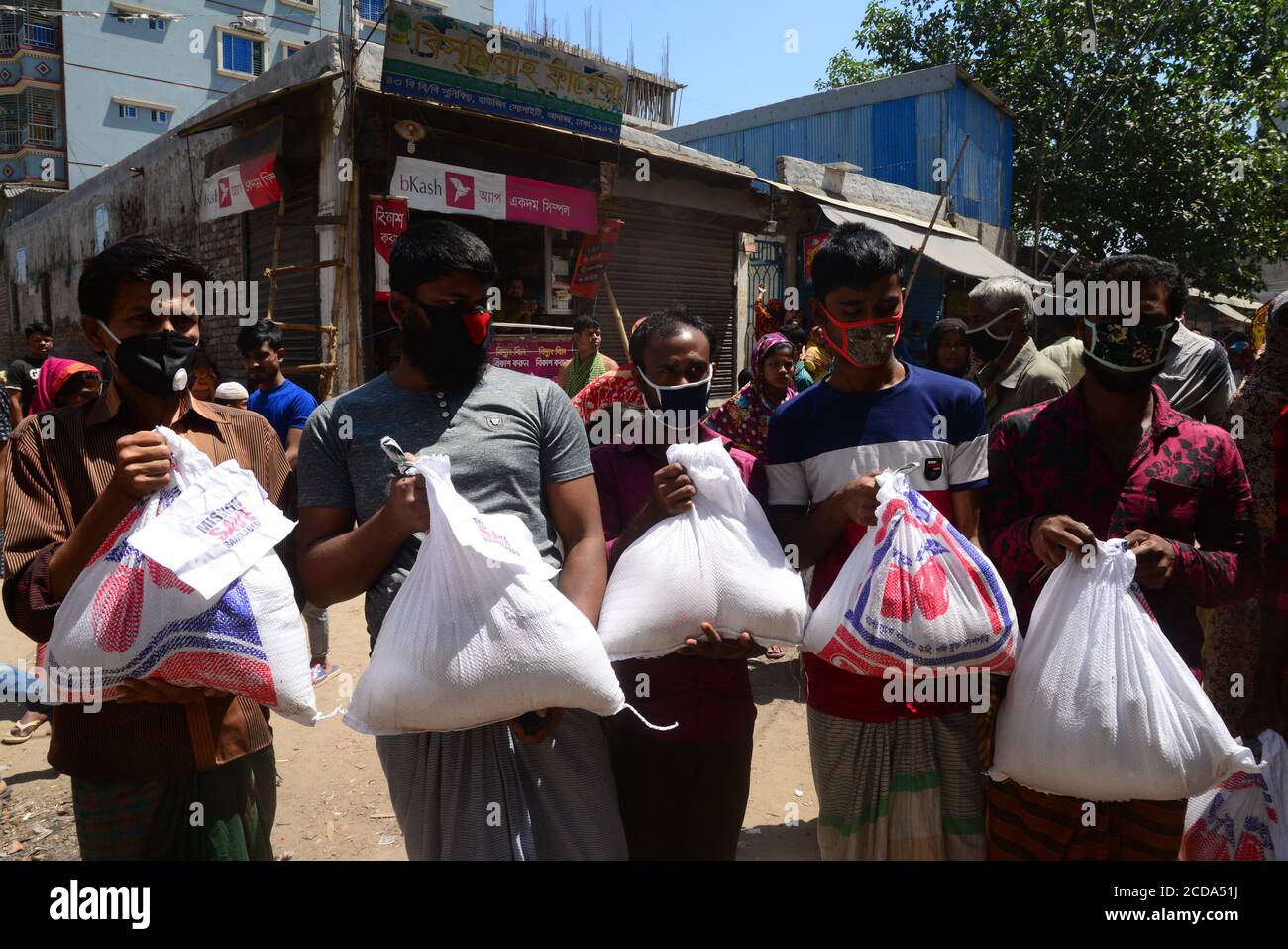 Bangladeshi poor people shows food items after recived relife during ...