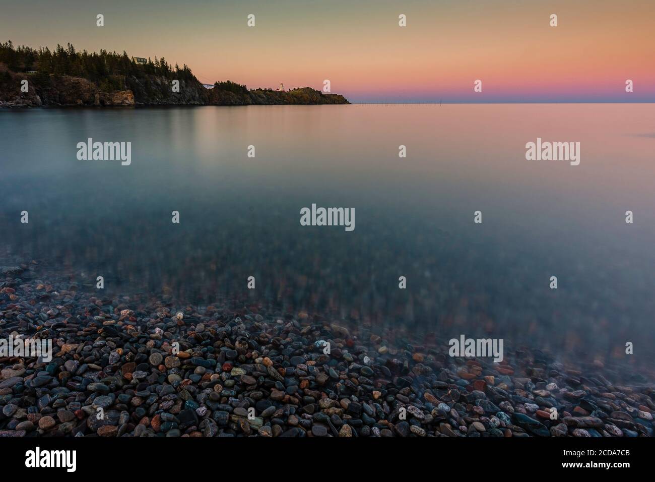 Long exposure of lighthouse and rocky ocean shoreline Stock Photo - Alamy