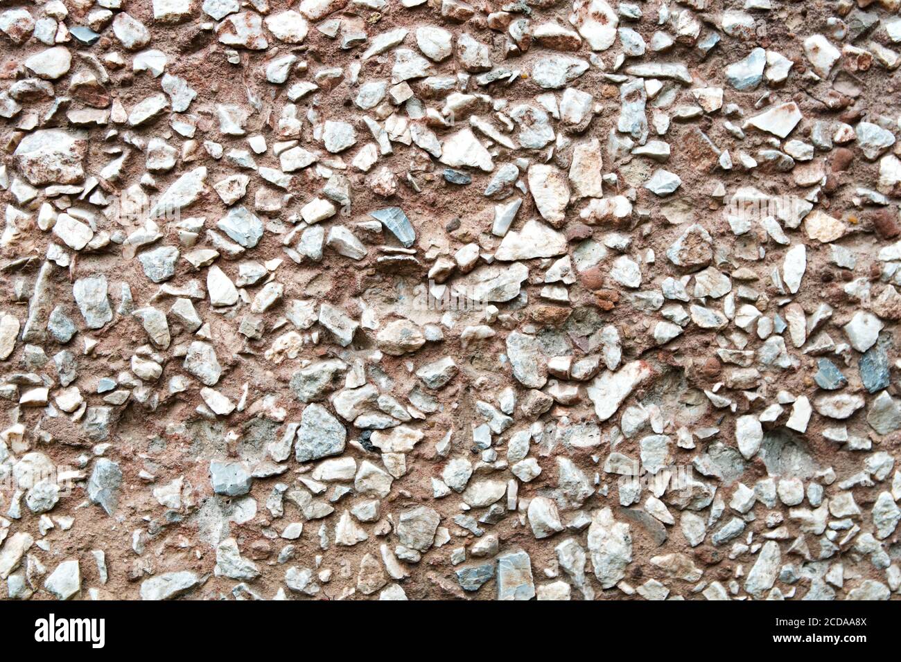Texture pattern. Brown concrete wall facing by white granite chips ...