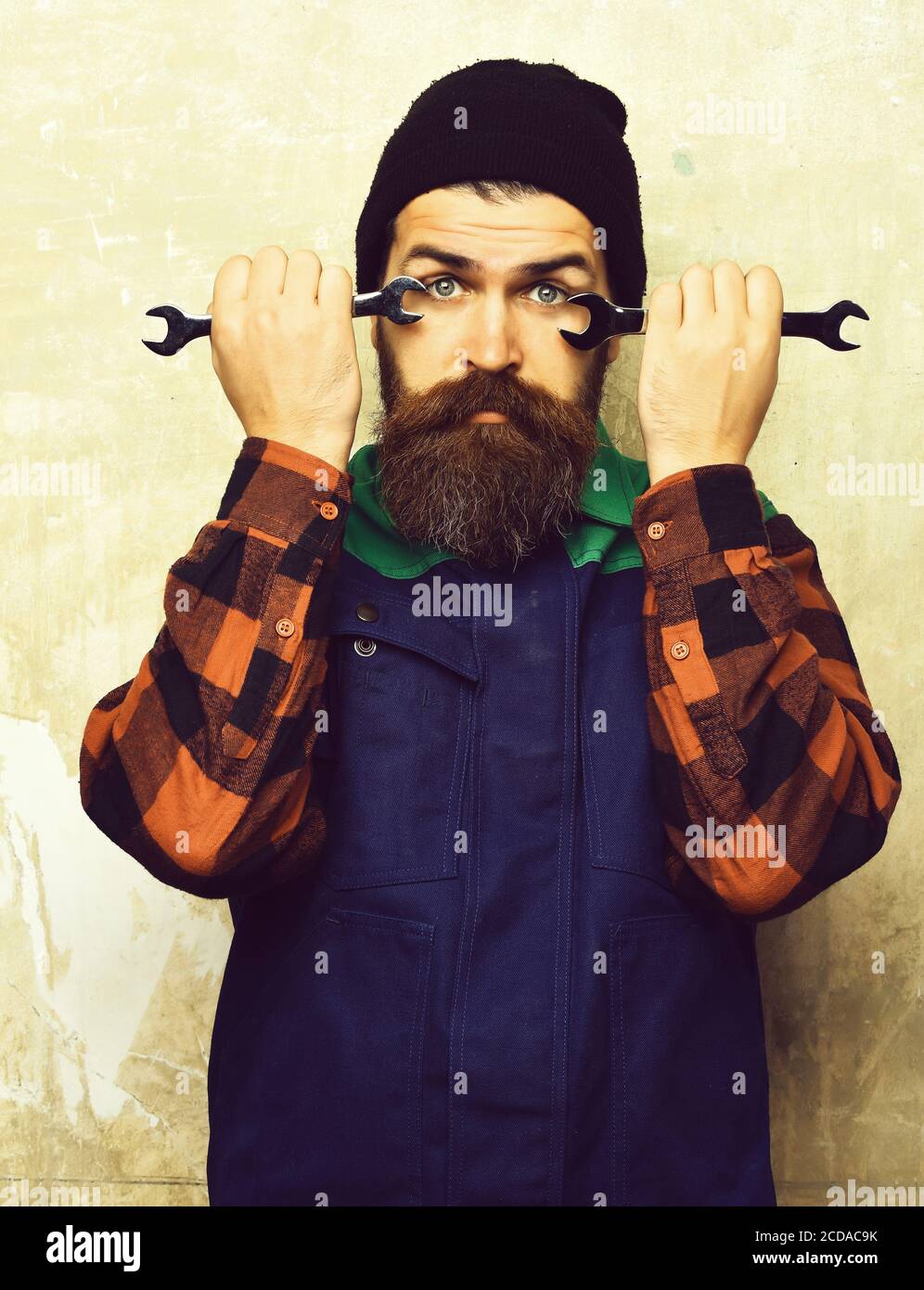 Bearded man, long beard. Brutal caucasian mechanic, surprised unshaven ...