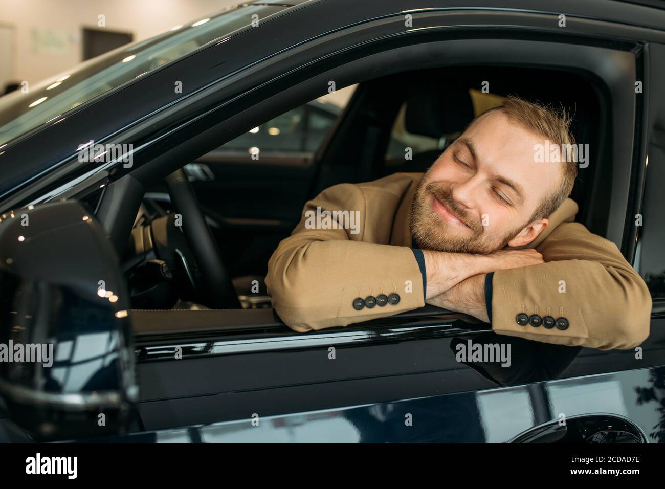 happy caucasian guy now the owner of business class auto. man make ...