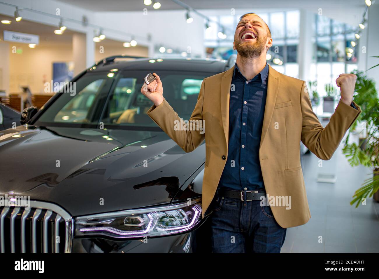 happy cheerful caucasian man owner of new car, stand next to his new ...