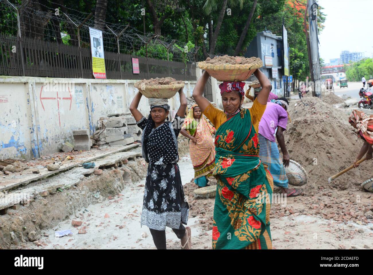Bangladeshi Daily Labor works without facemask at a road construction ...