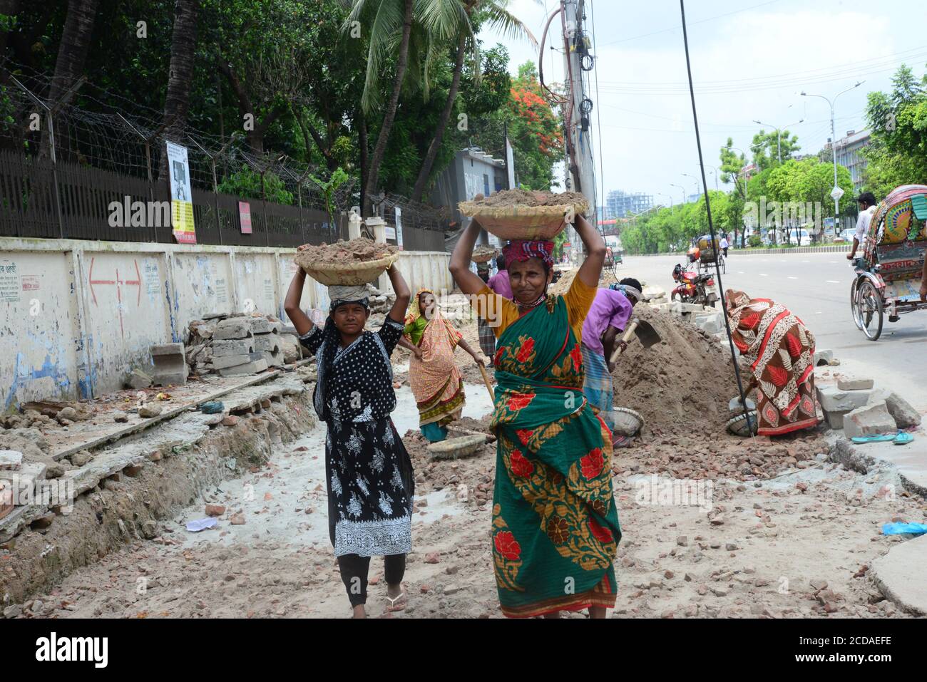 Bangladeshi Daily Labor works without facemask at a road construction ...
