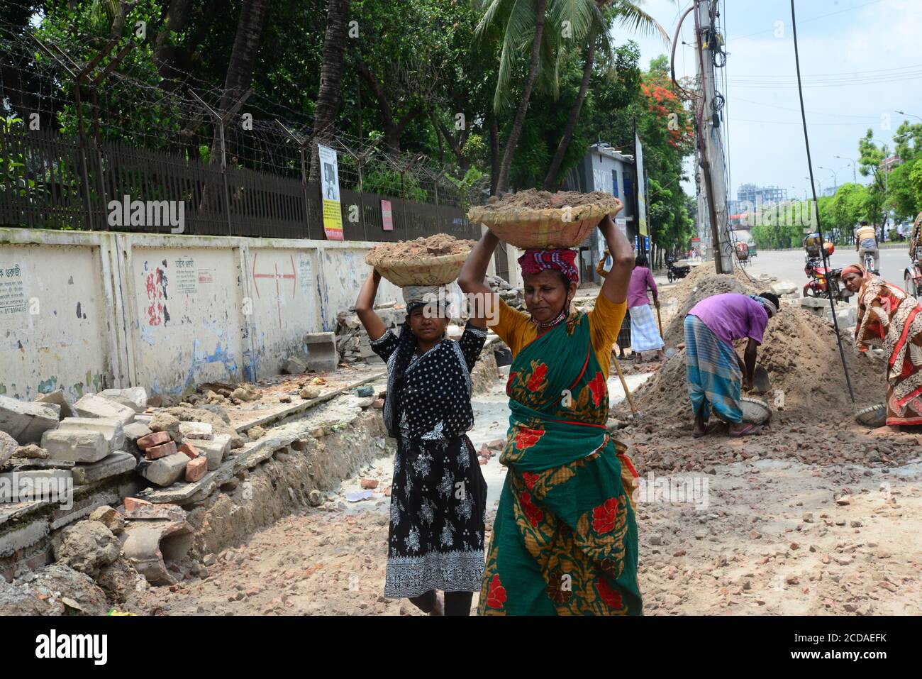 Bangladeshi Daily Labor works without facemask at a road construction ...