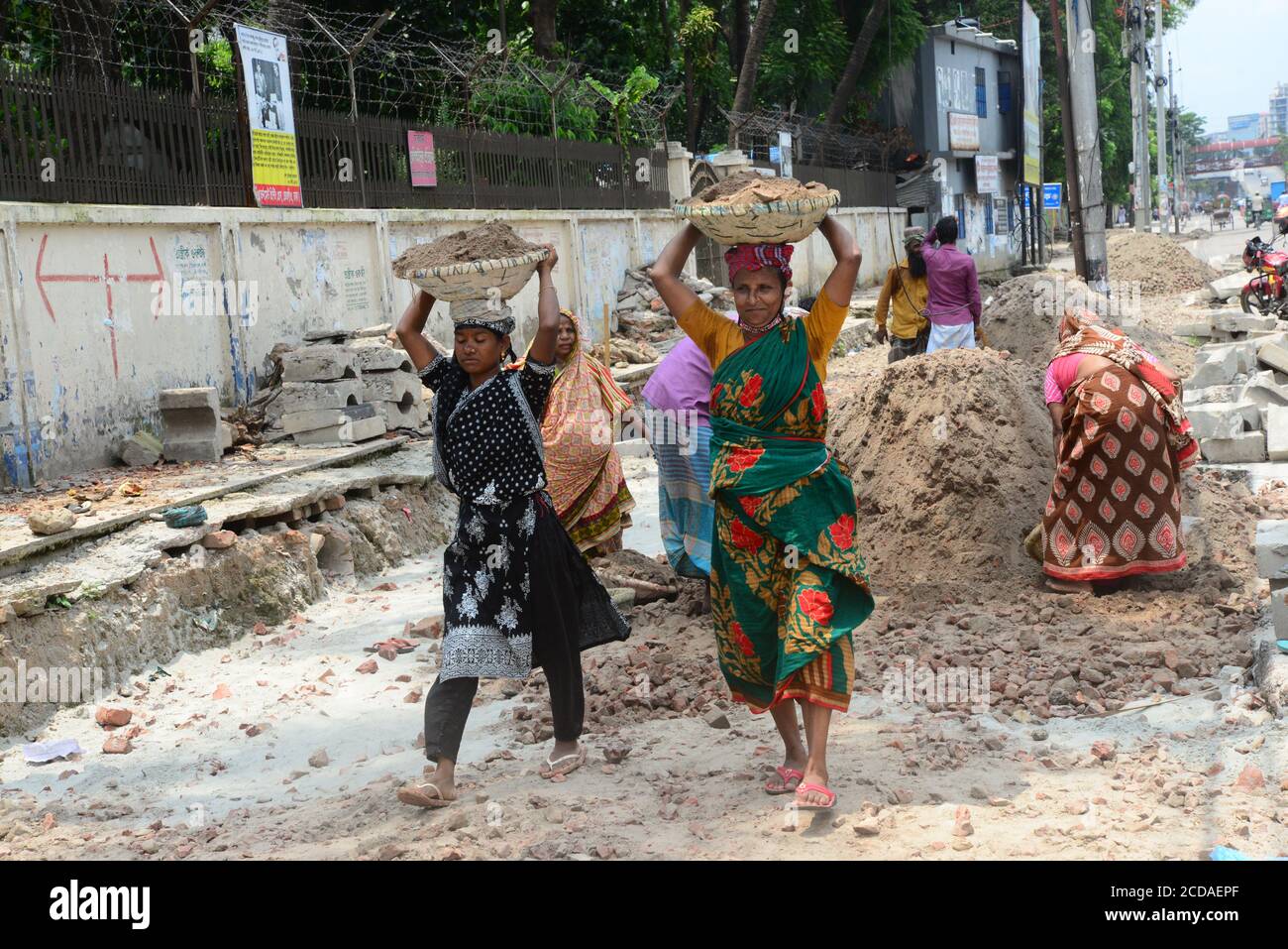 Bangladeshi Daily Labor works without facemask at a road construction ...