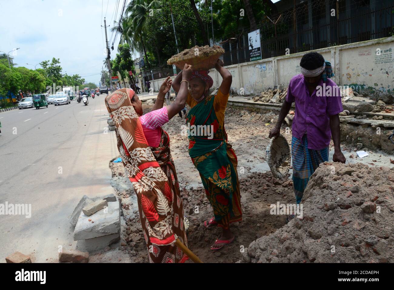 Bangladeshi Daily Labor works without facemask at a road construction ...