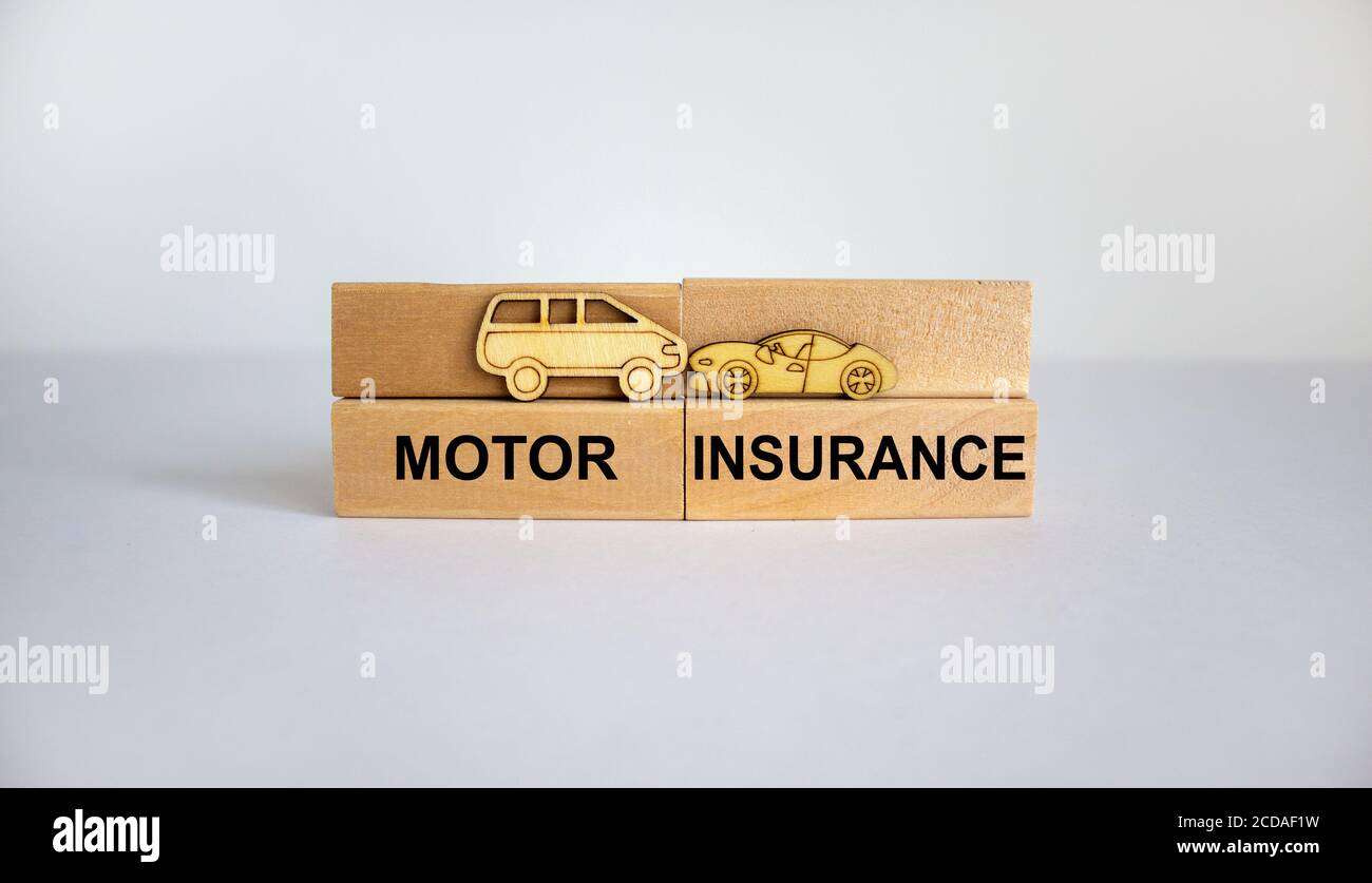 Wooden blocks with words 'motor insurance', wooden models of car ...