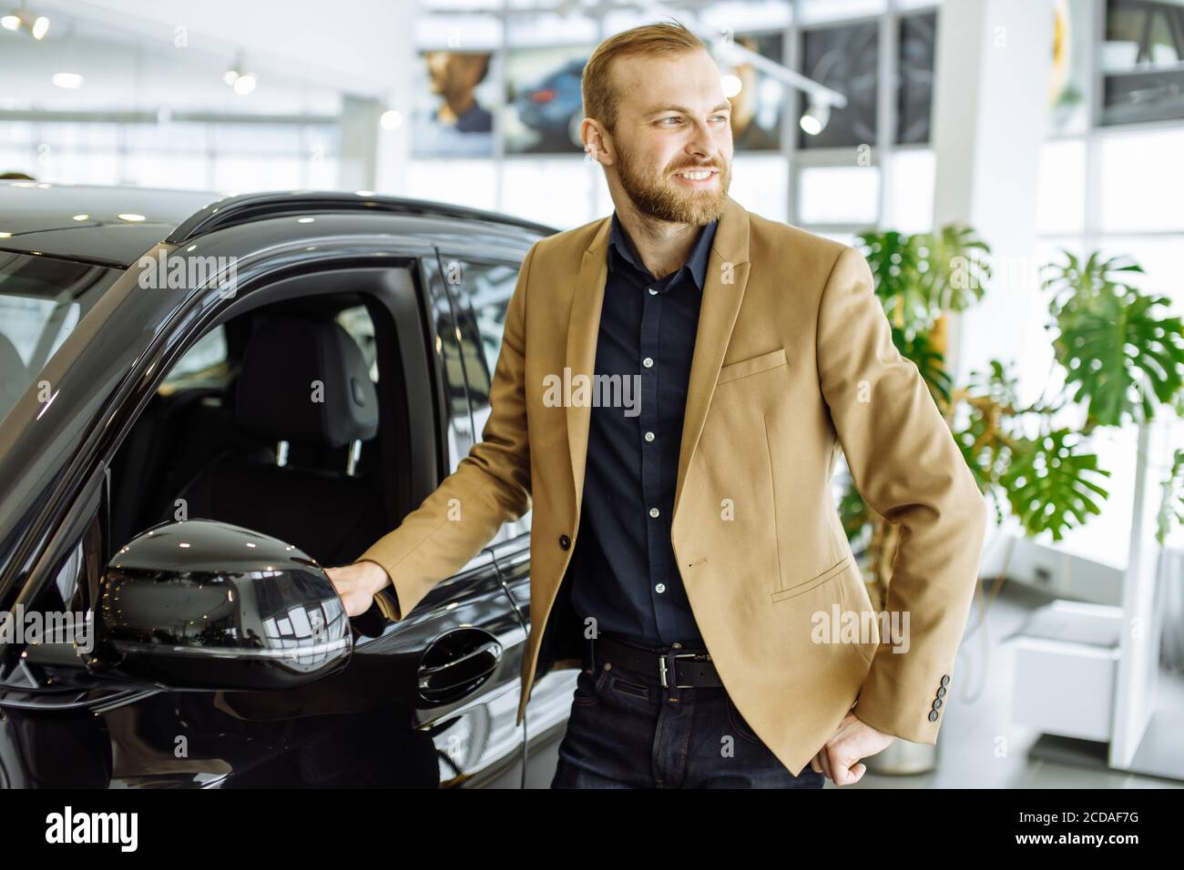 happy caucasian guy now the owner of business class auto. man make ...