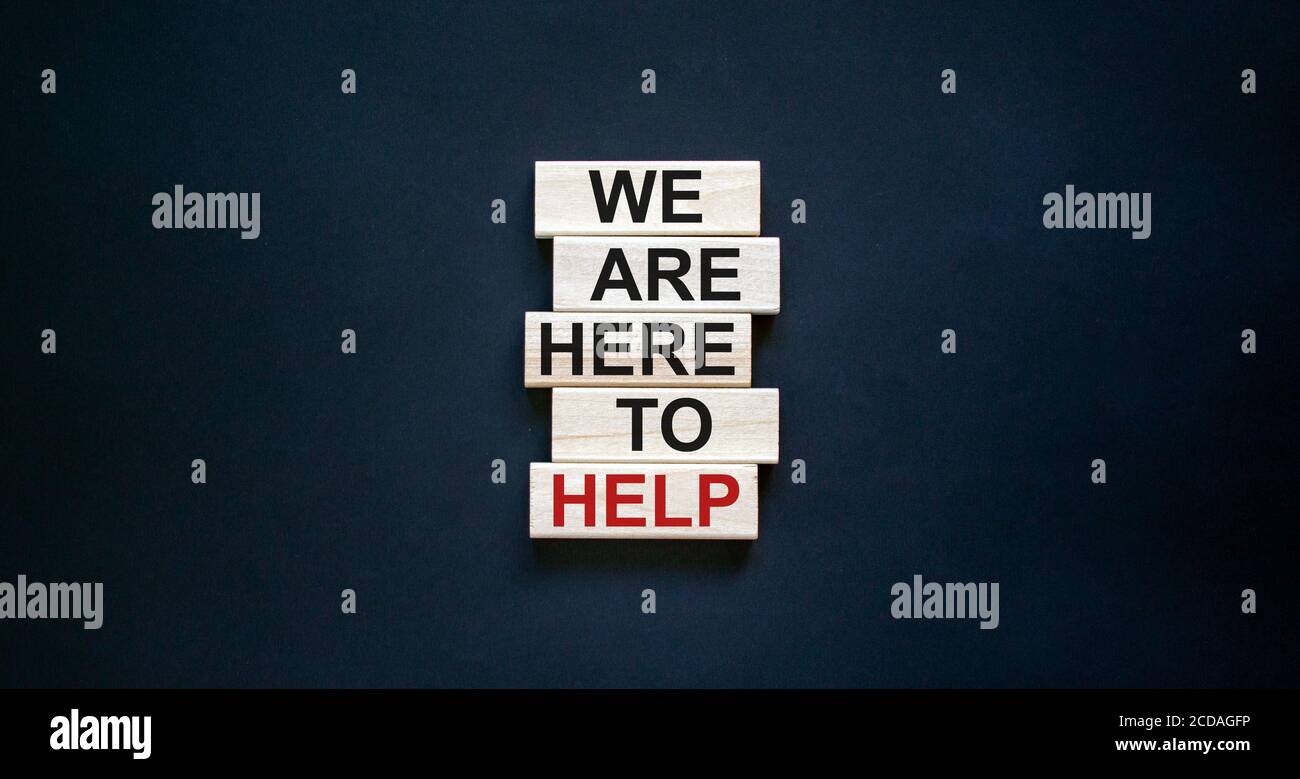 Wooden blocks with text 'we are here to help'. Beautiful black ...