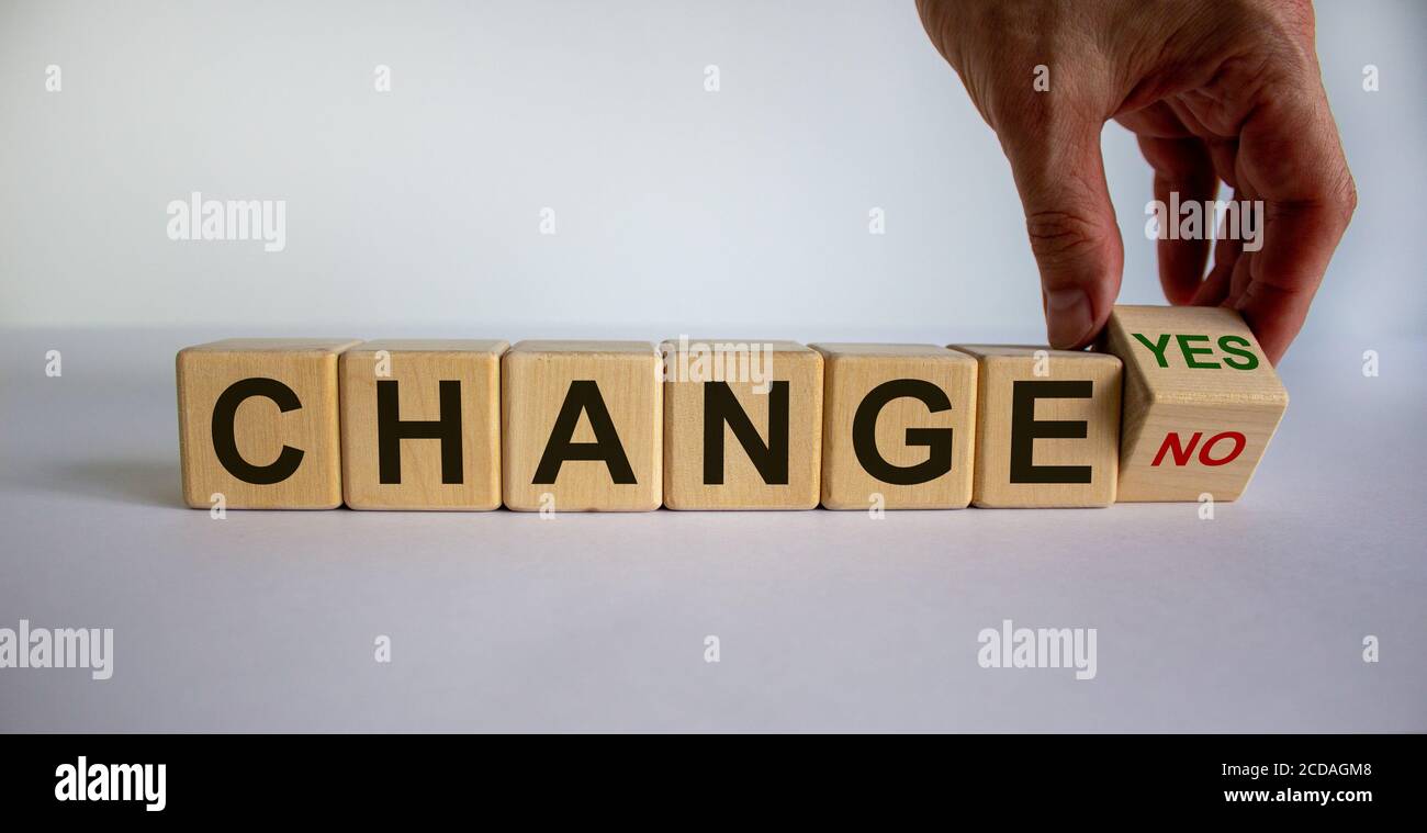 Hand turns a cube and changes the expression 'change no' to 'change yes ...