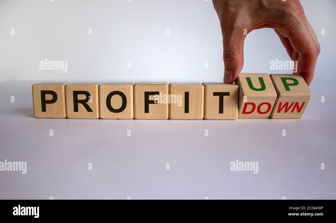 Hand turns cubes and changes the expression 'profit down' to 'profit up ...