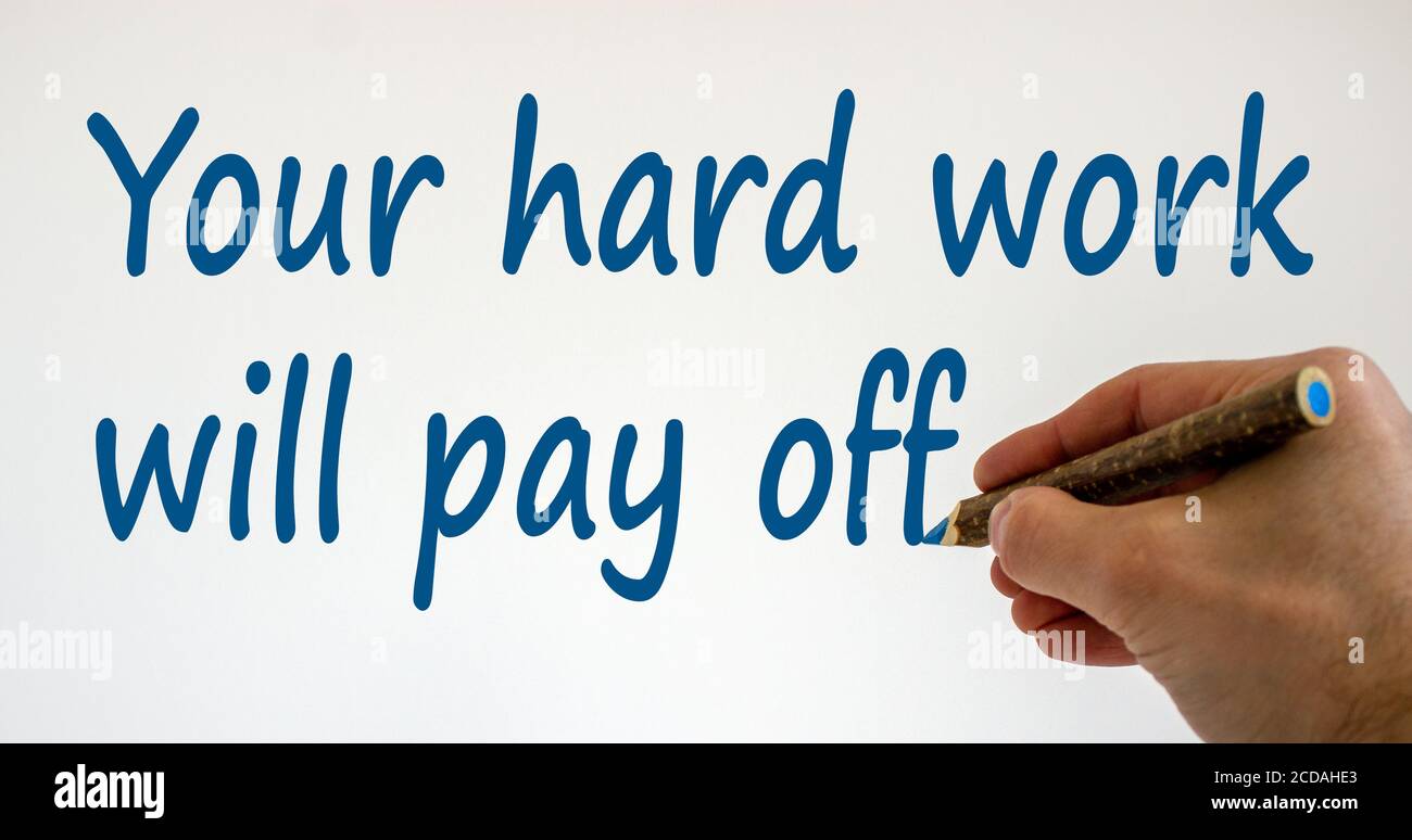 Hand with blue pencil writing 'your hard work will pay off', isolated ...