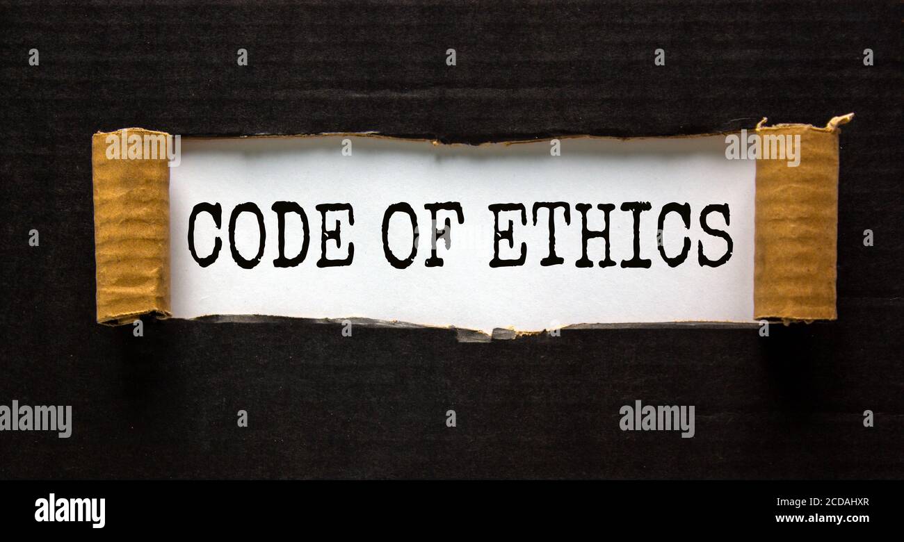 The words 'code of ethics' appearing behind torn black paper. Beautiful ...