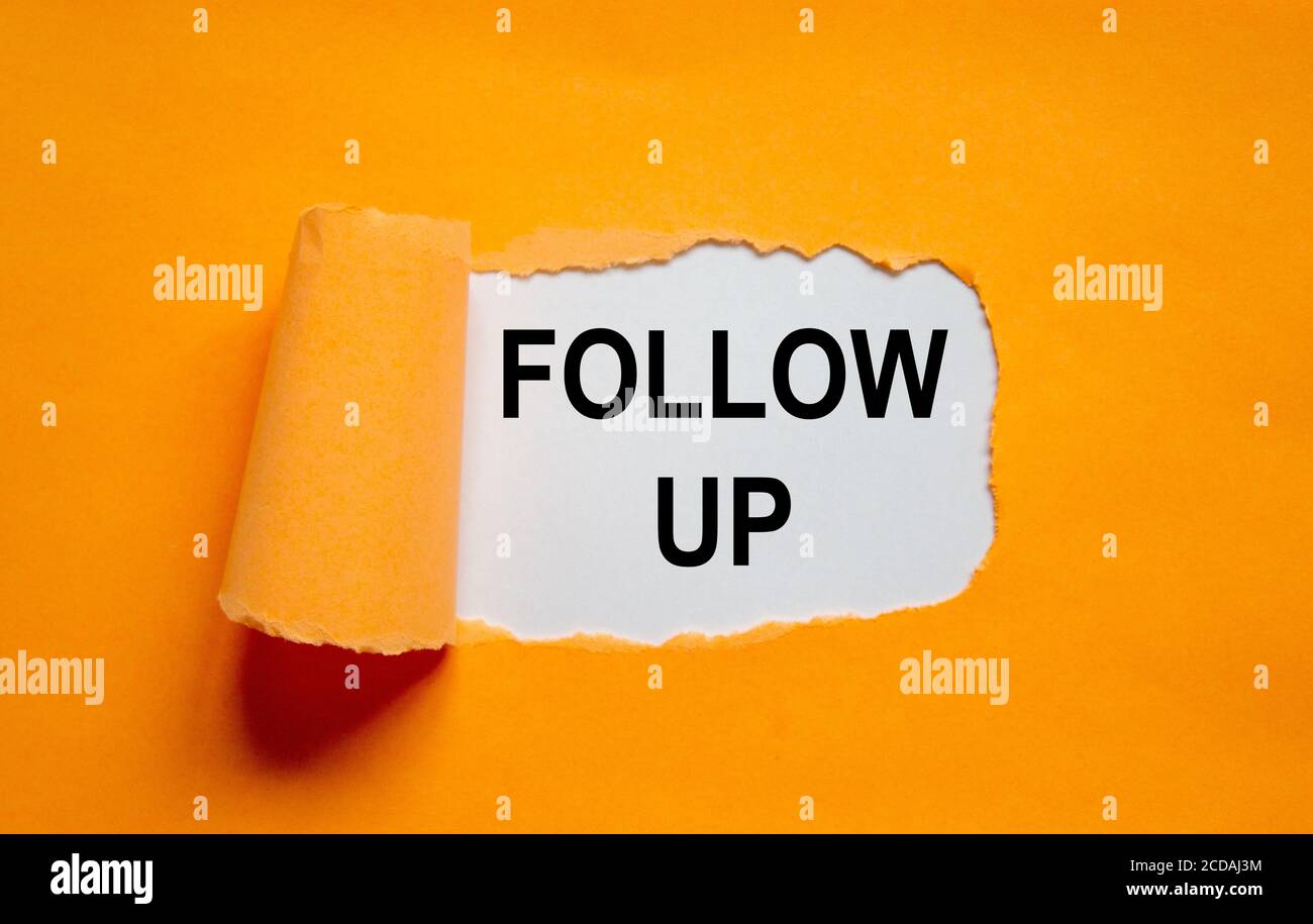 The words 'follow up' appearing behind torn orange paper. Business ...