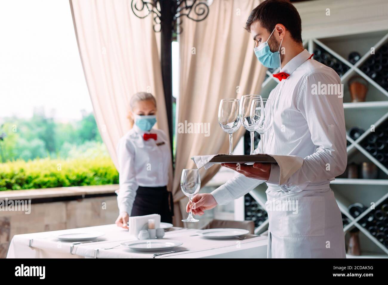 Table setting restaurant waiter mask hi-res stock photography and ...