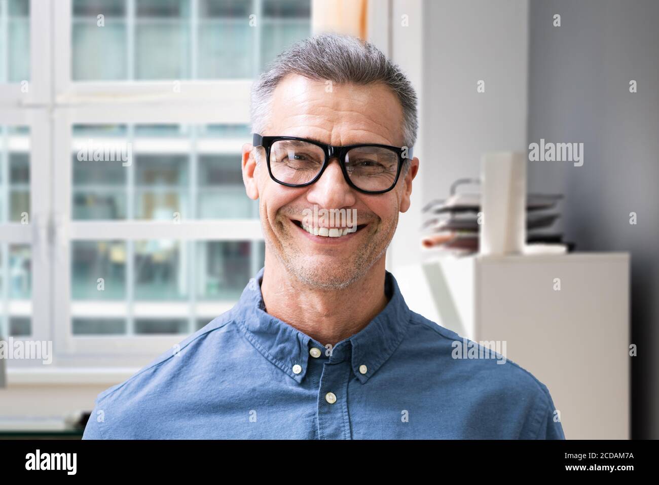Man smiling indoors in living hi-res stock photography and images - Alamy