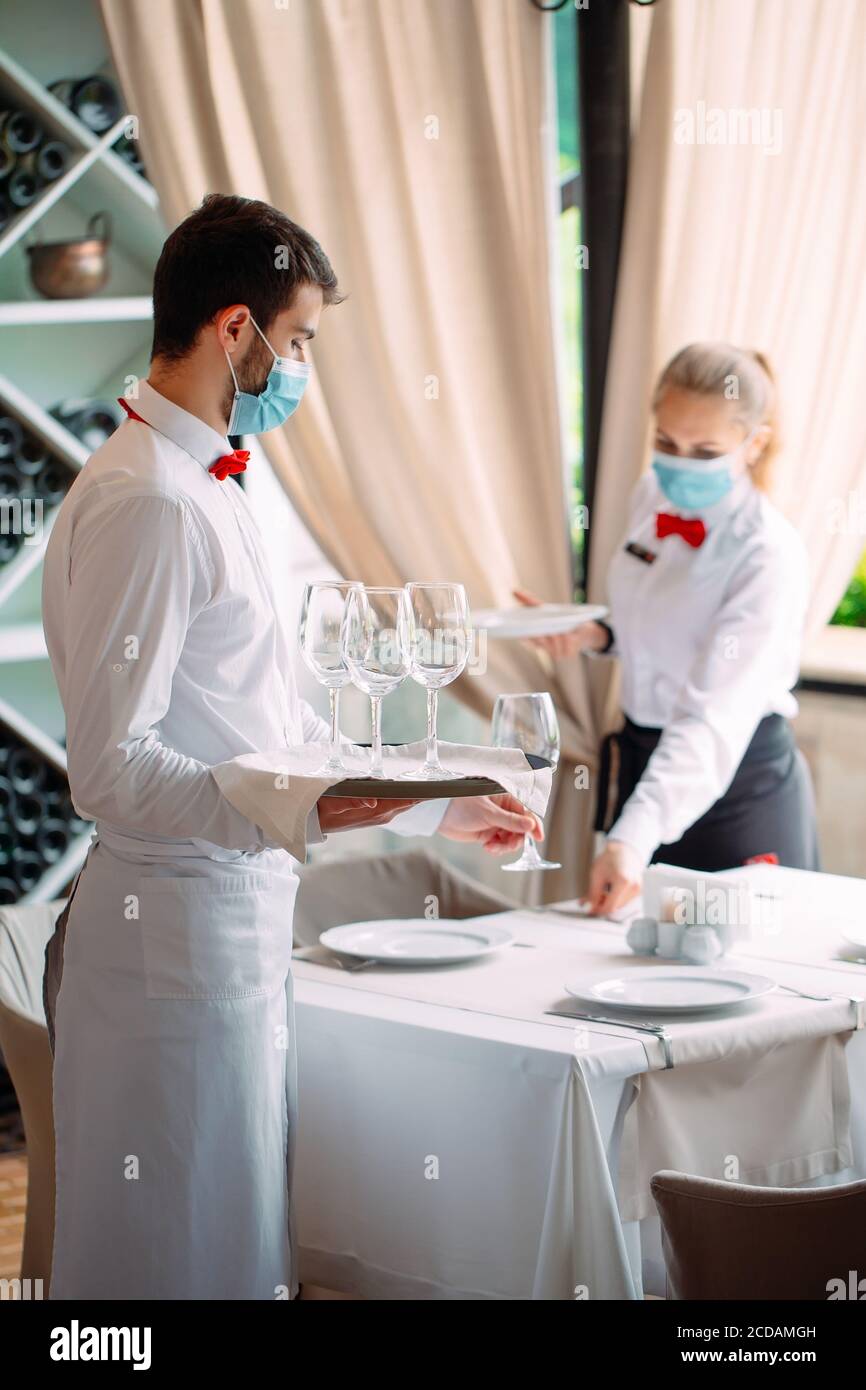 Table setting restaurant waiter mask hi-res stock photography and ...