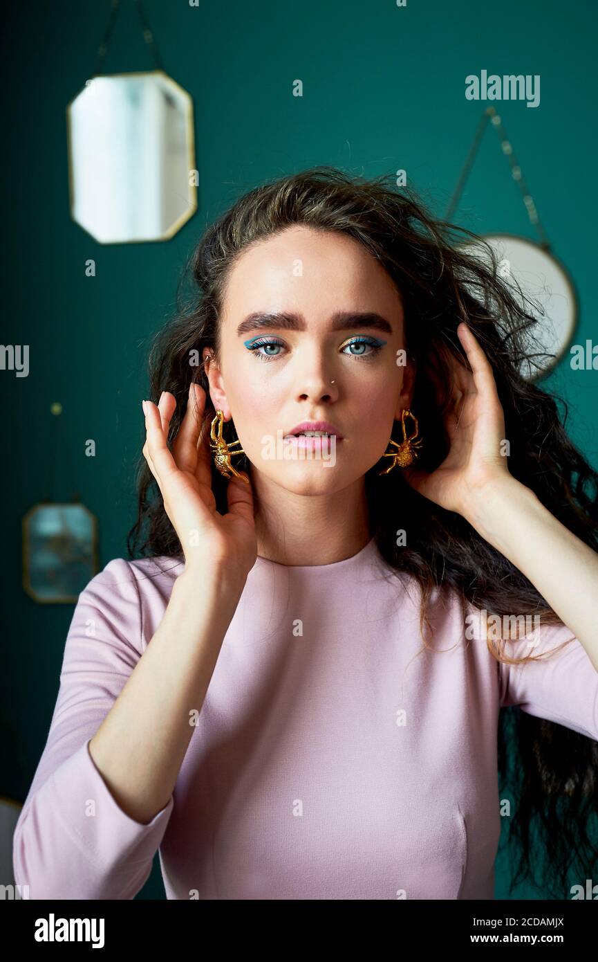 Portrait of a beautiful girl with long curly hair, natural thick ...