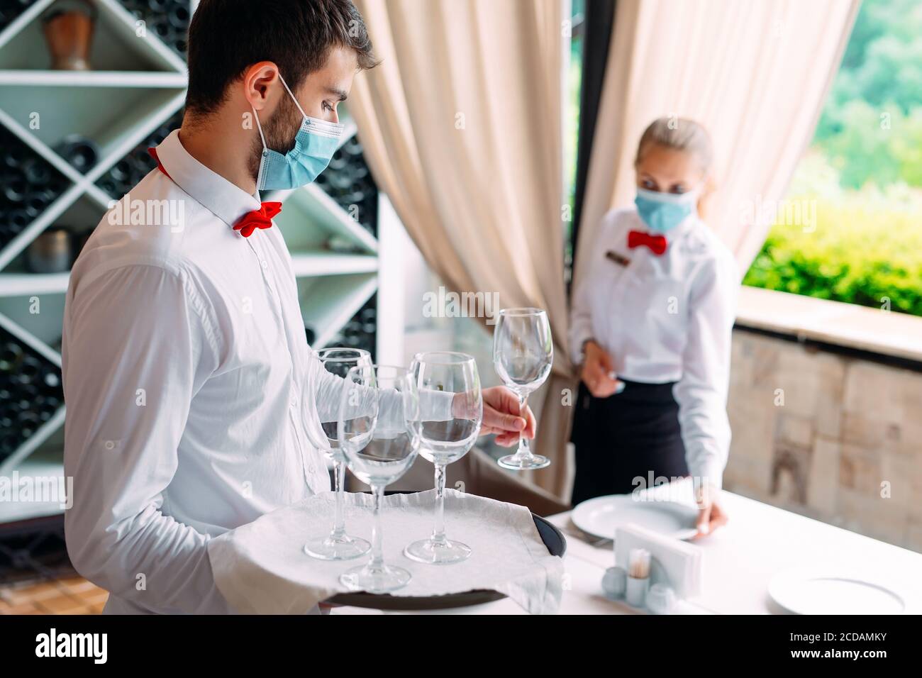 Table setting restaurant waiter mask hi-res stock photography and ...