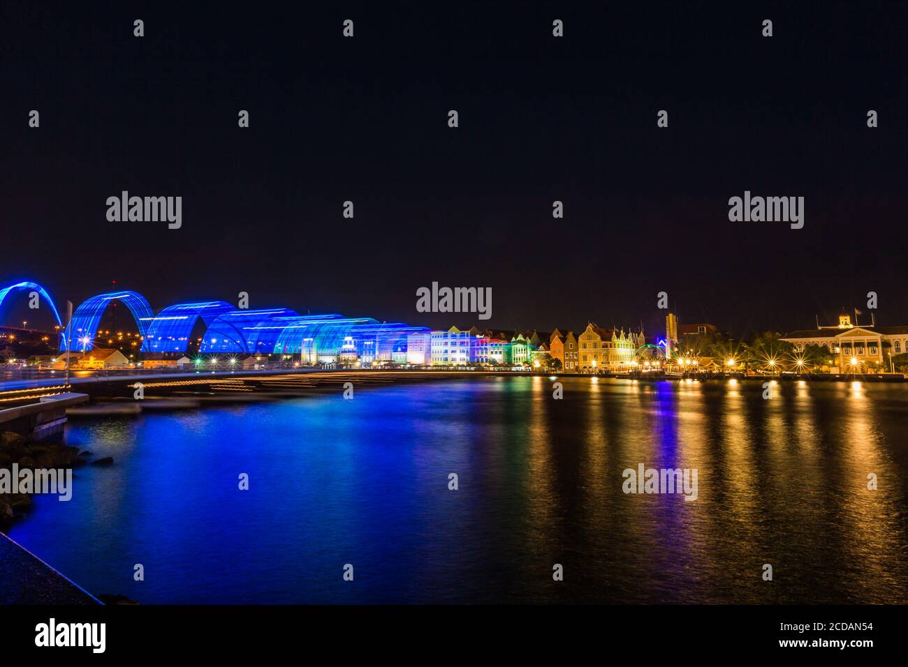 Night view of the Queen Emma Bridge, a swinging pontoon bridge ...