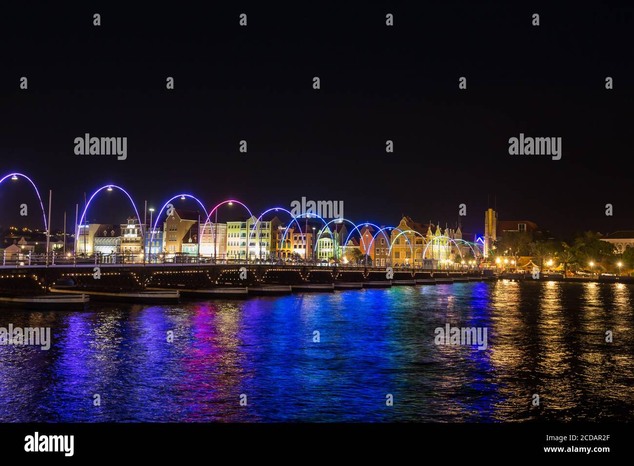 Night view of the Queen Emma Bridge, a swinging pontoon bridge ...