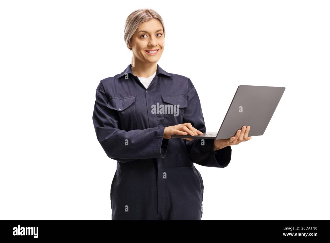 Female worker in a navy blue overall uniform with a laptop computer ...