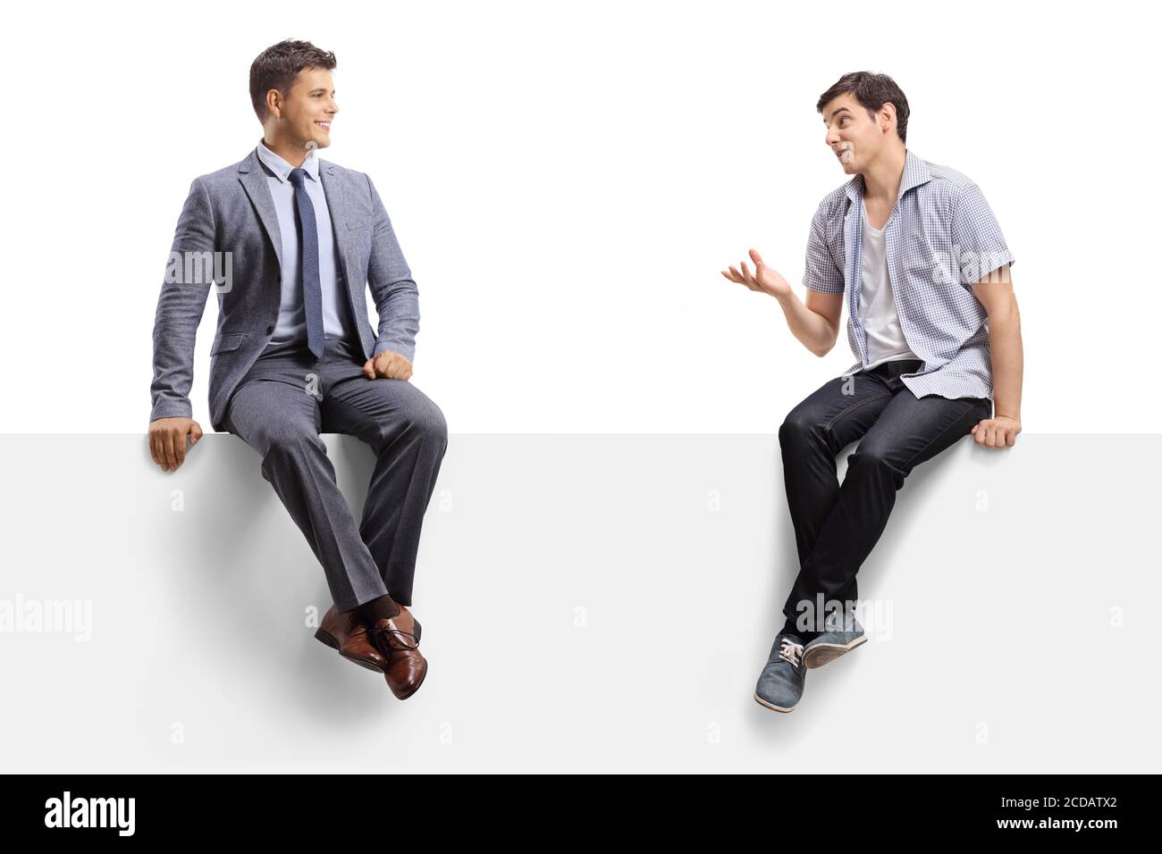 Casual guy talking to a man in a suit and tie and sitting on a panel ...