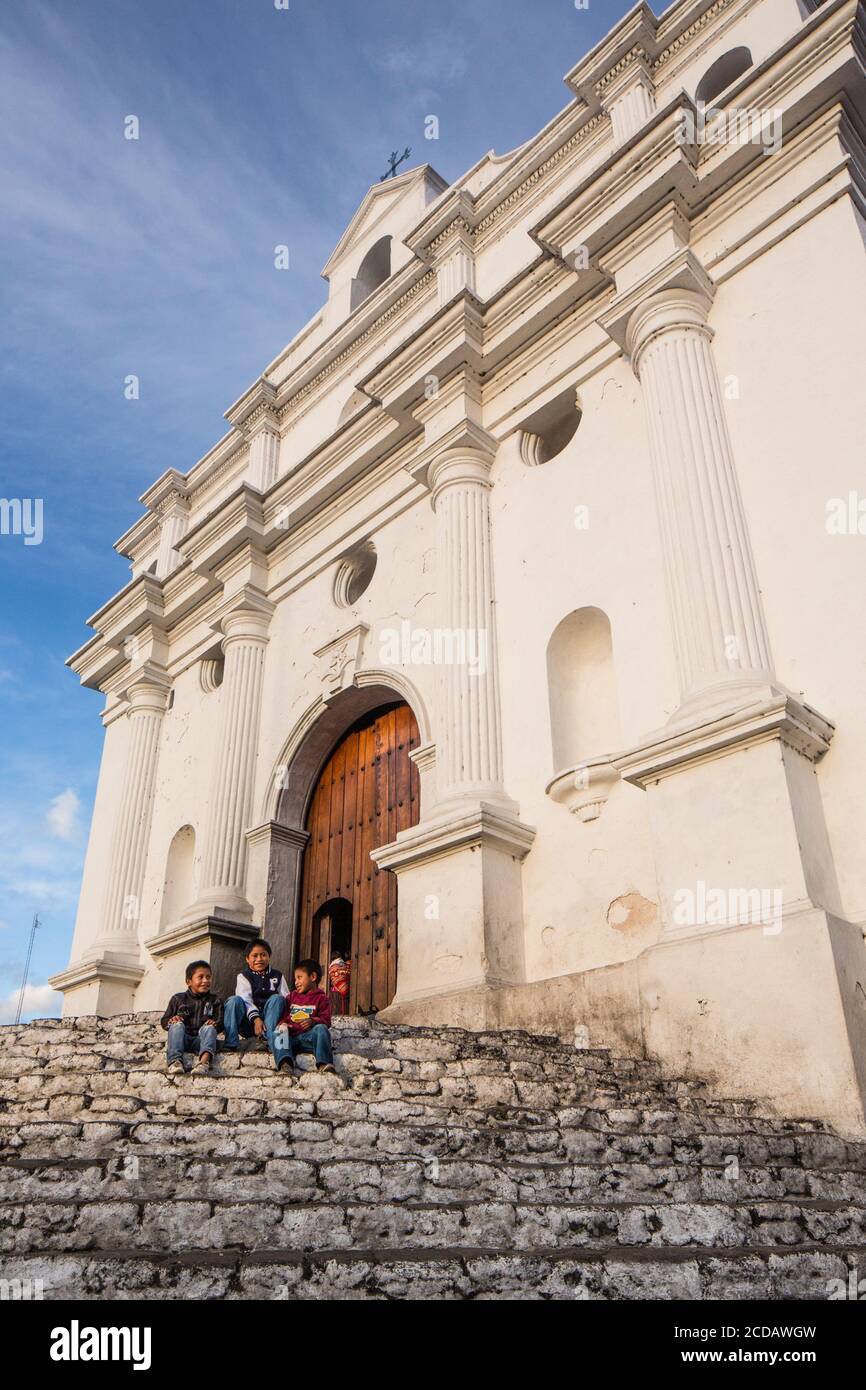 Young Mayan boys sit on the Mayan steps of the colonial Church of Santo ...
