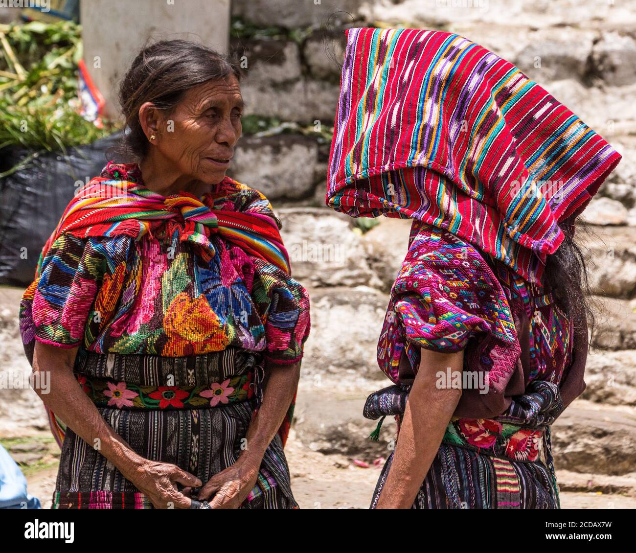 Two Quiche Mayan woman in traditional dress visit in the market on the ...