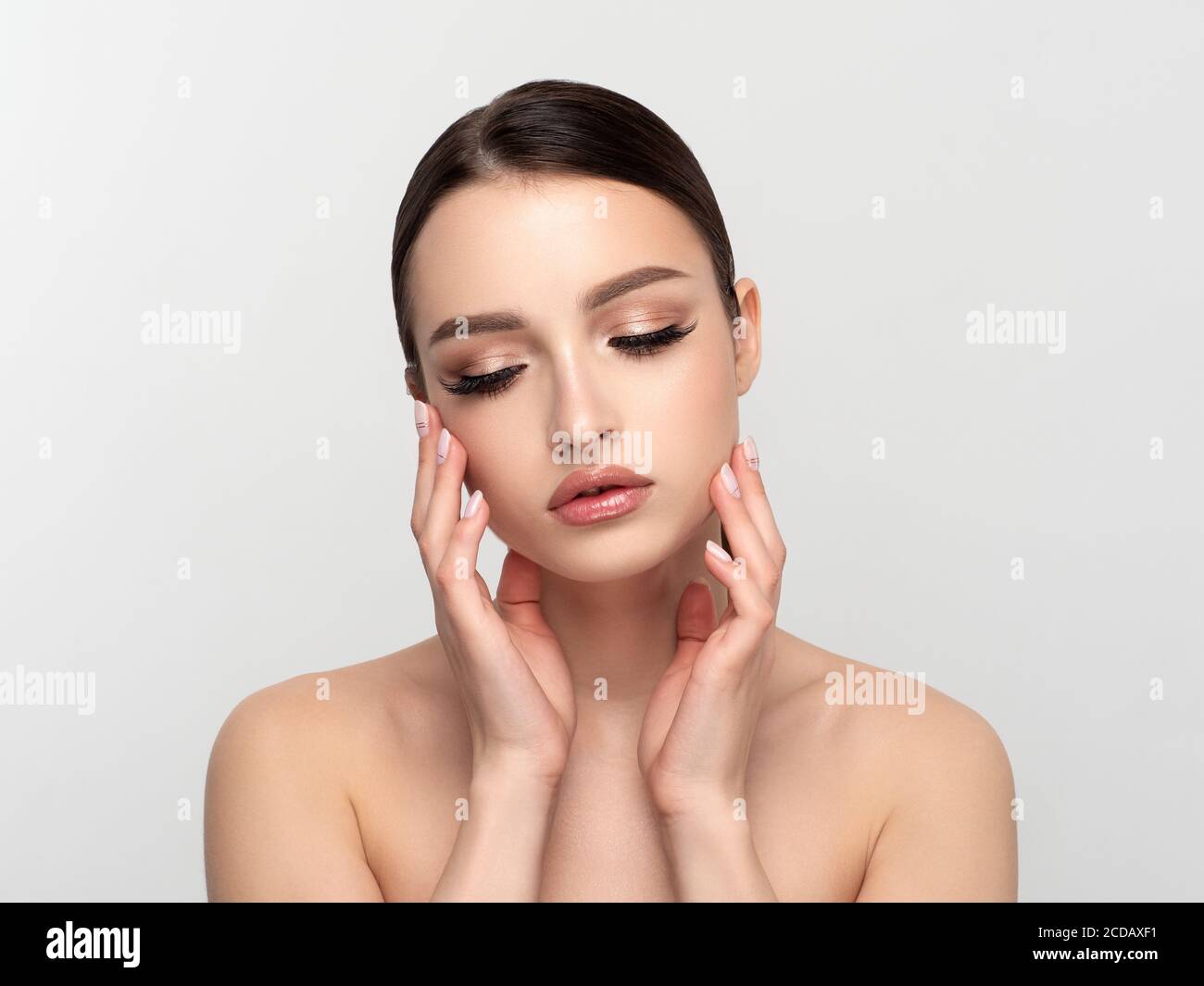 Young beautiful woman touching her face Stock Photo - Alamy