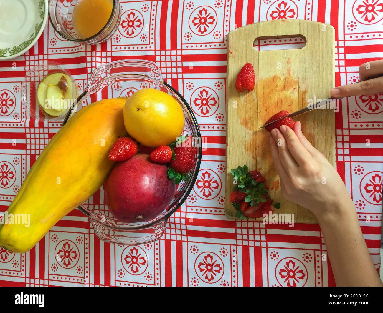 Fruit concept image - Female hands cutting strawberry in small slices ...
