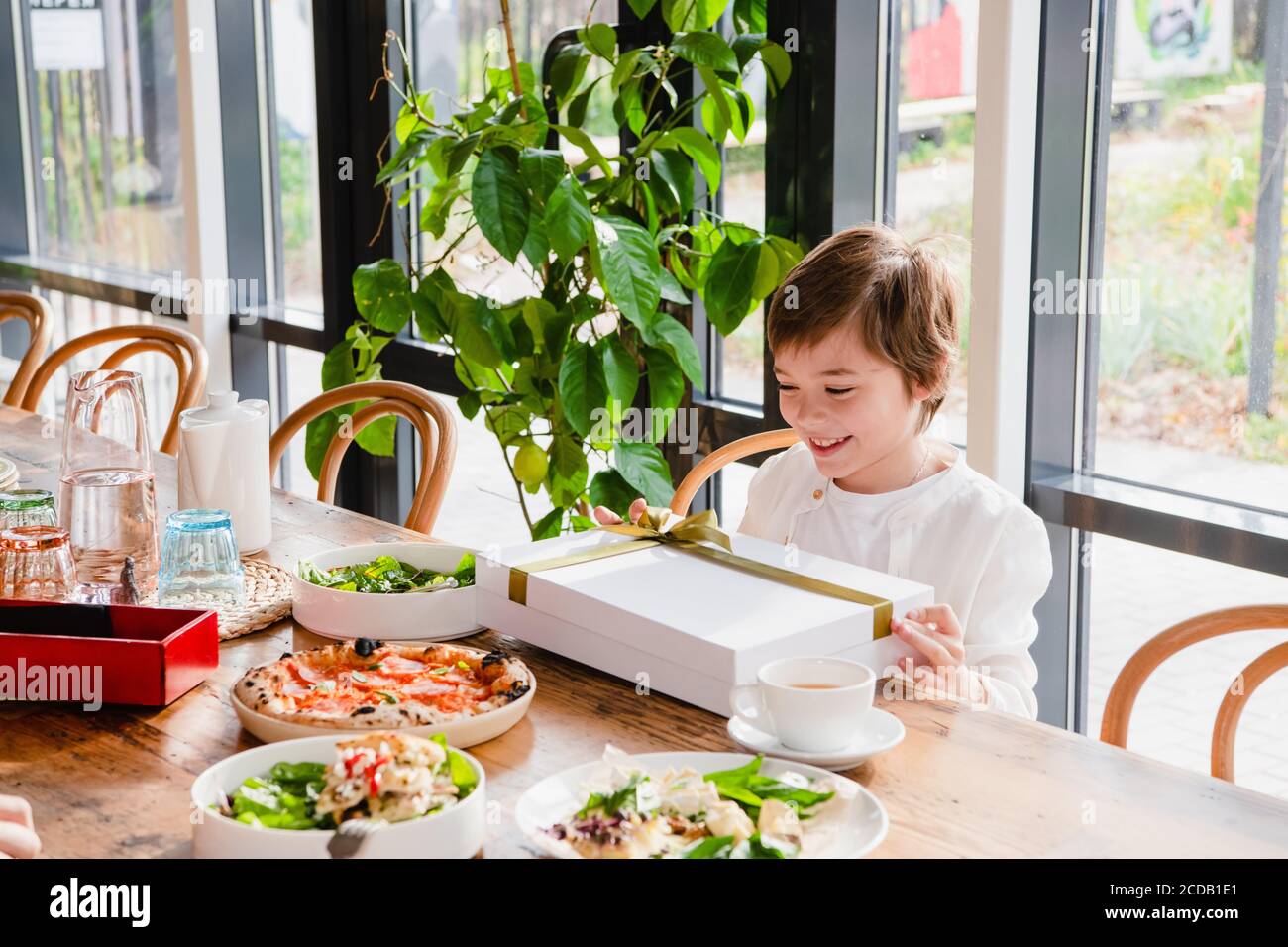 A happy child receiving a beautiful gift Stock Photo - Alamy