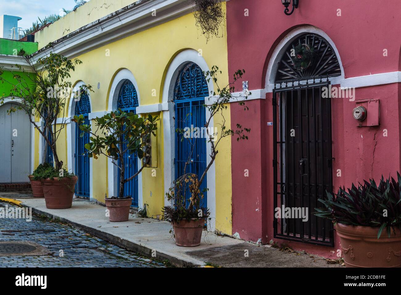 Colorfully painted houses on a narrow cobblestone street in the ...