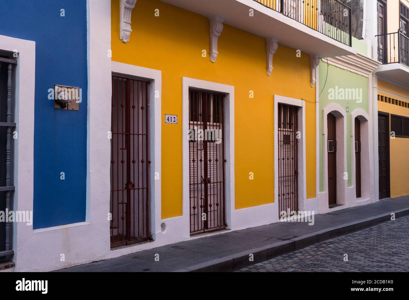 Colorfully painted houses on a narrow cobblestone street in the ...