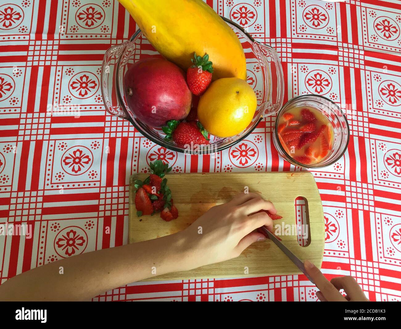Hand cutting strawberry hi-res stock photography and images - Alamy
