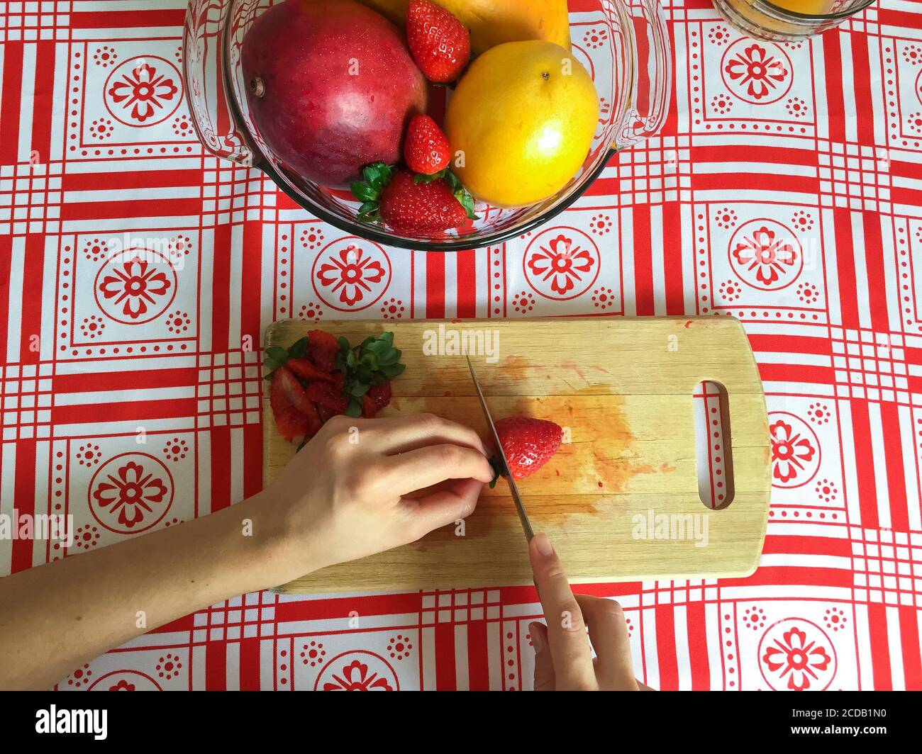Fruit concept image - Female hands cutting strawberry in small slices ...