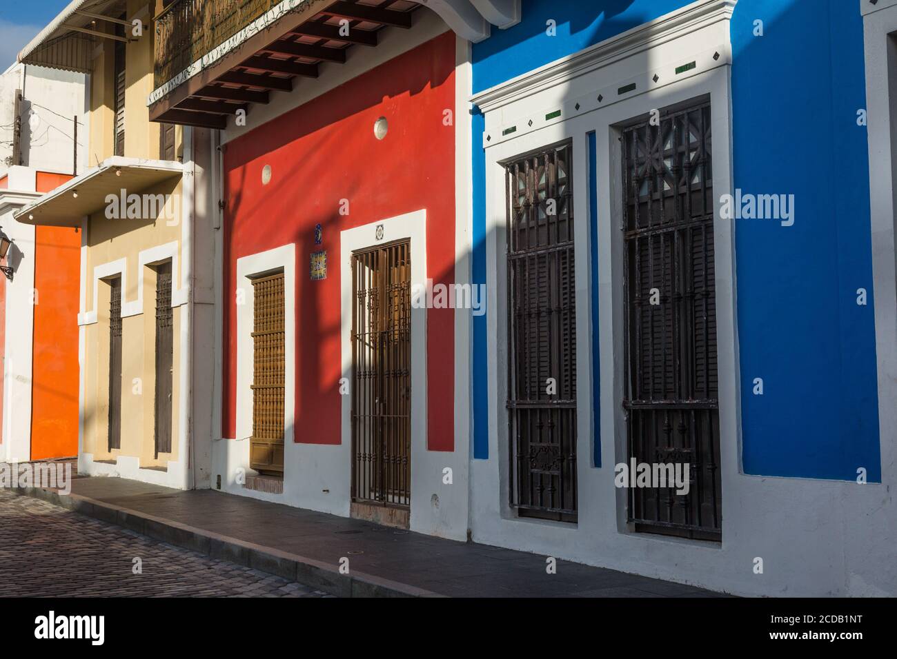 Colorfully painted houses on a narrow cobblestone street in the ...