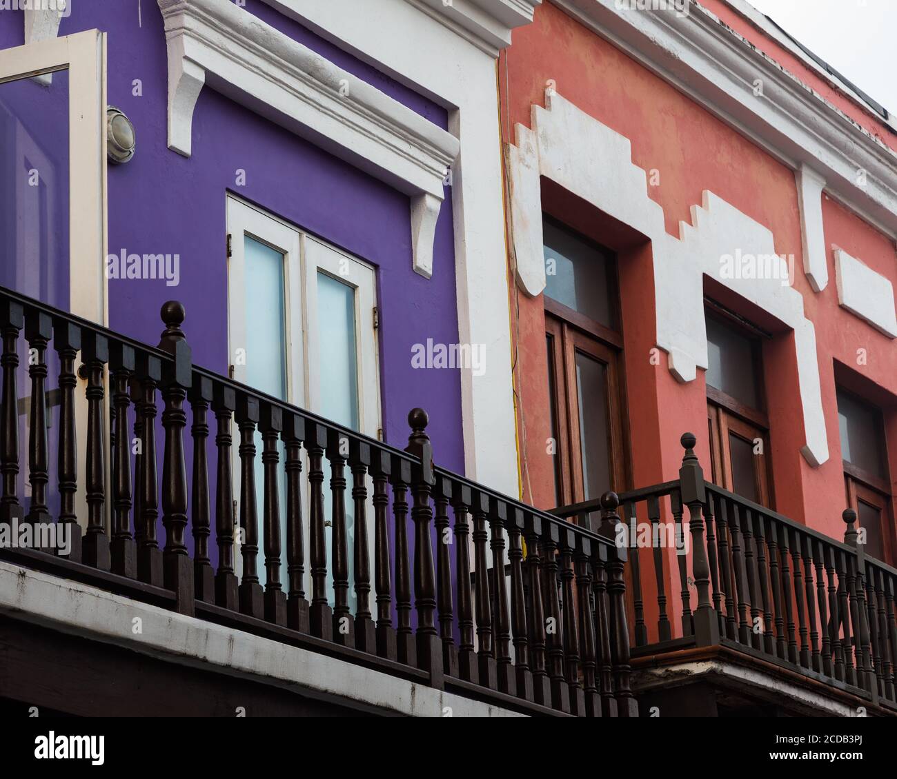 Wooden balconies on olorfully painted houses in the historic colonial ...