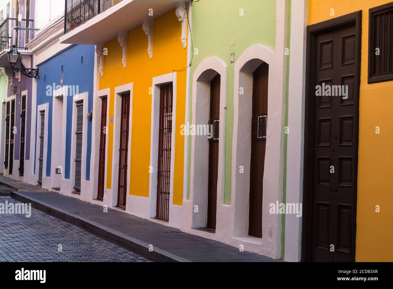 Colorfully painted houses on a narrow cobblestone street in the ...
