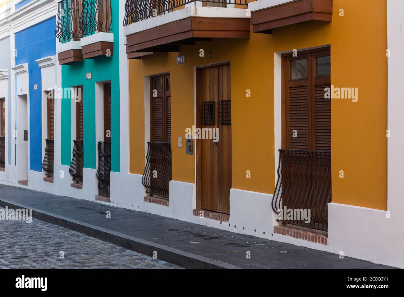 Colorfully painted houses on a narrow cobblestone street in the ...