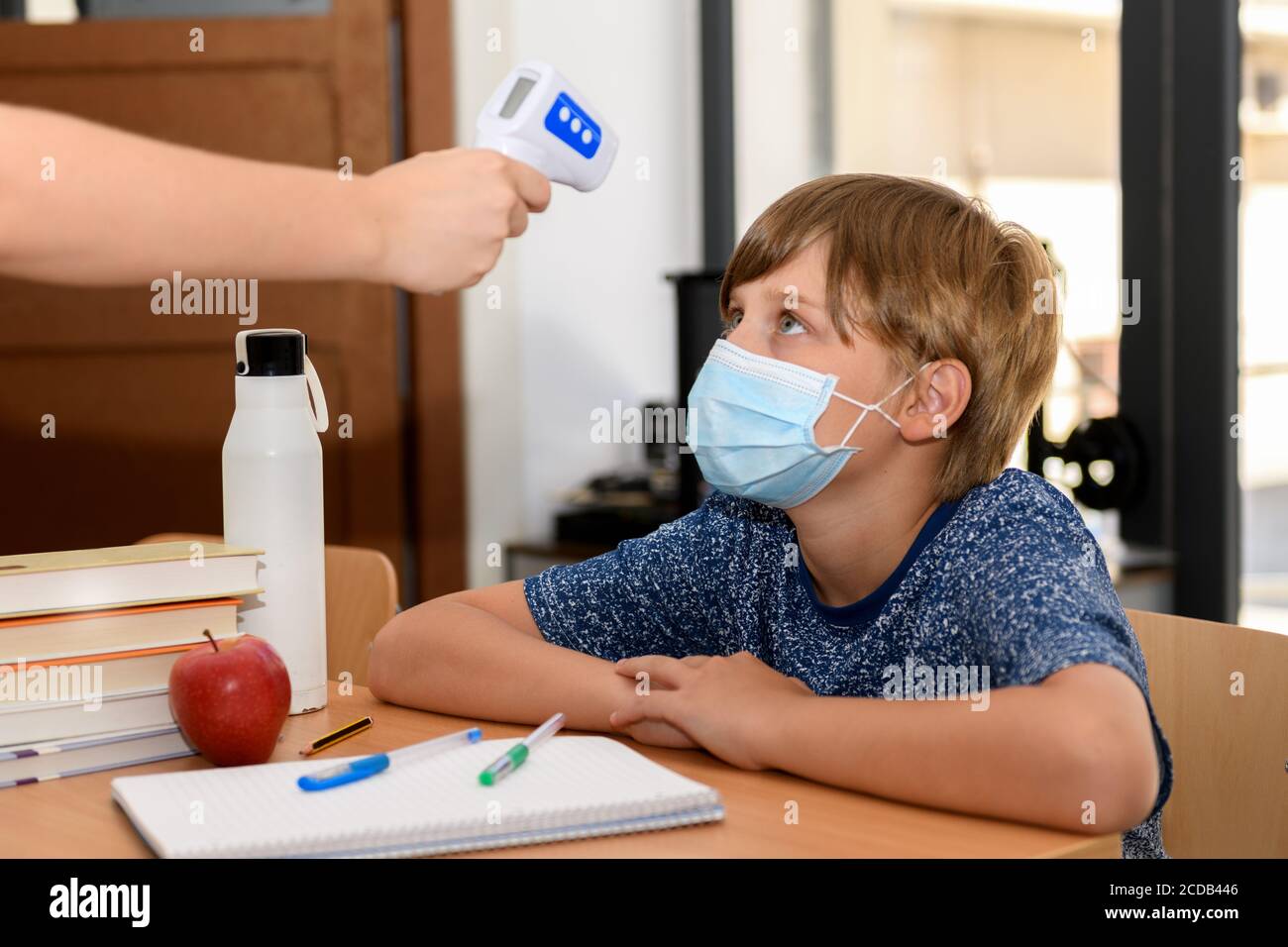 Digital thermometer scannering a kid's body temperature, new normal ...