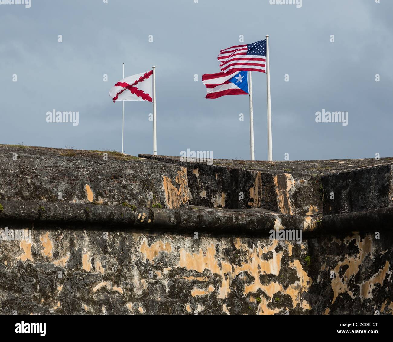 The Cross of Burgundy flag of Spain, the Puerto Rican and U.S. flags ...