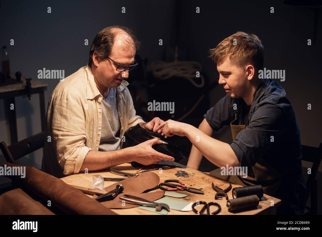 a respectable elderly shoemaker conducts a master class for a young boy ...