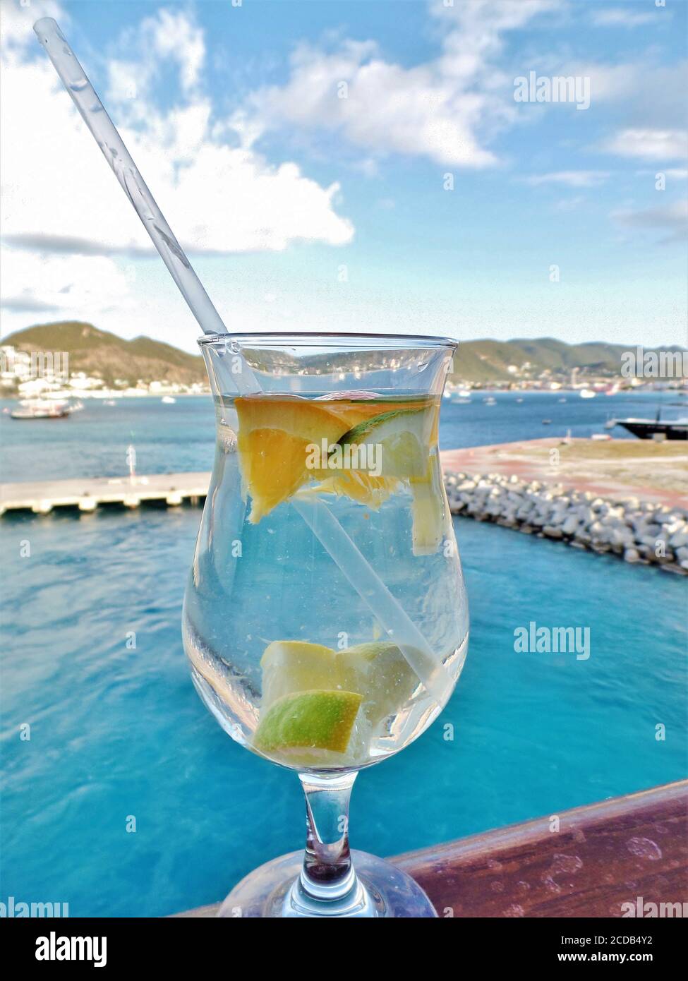Glass of water with fresh lime and lemon slices sitting on a cruise ...