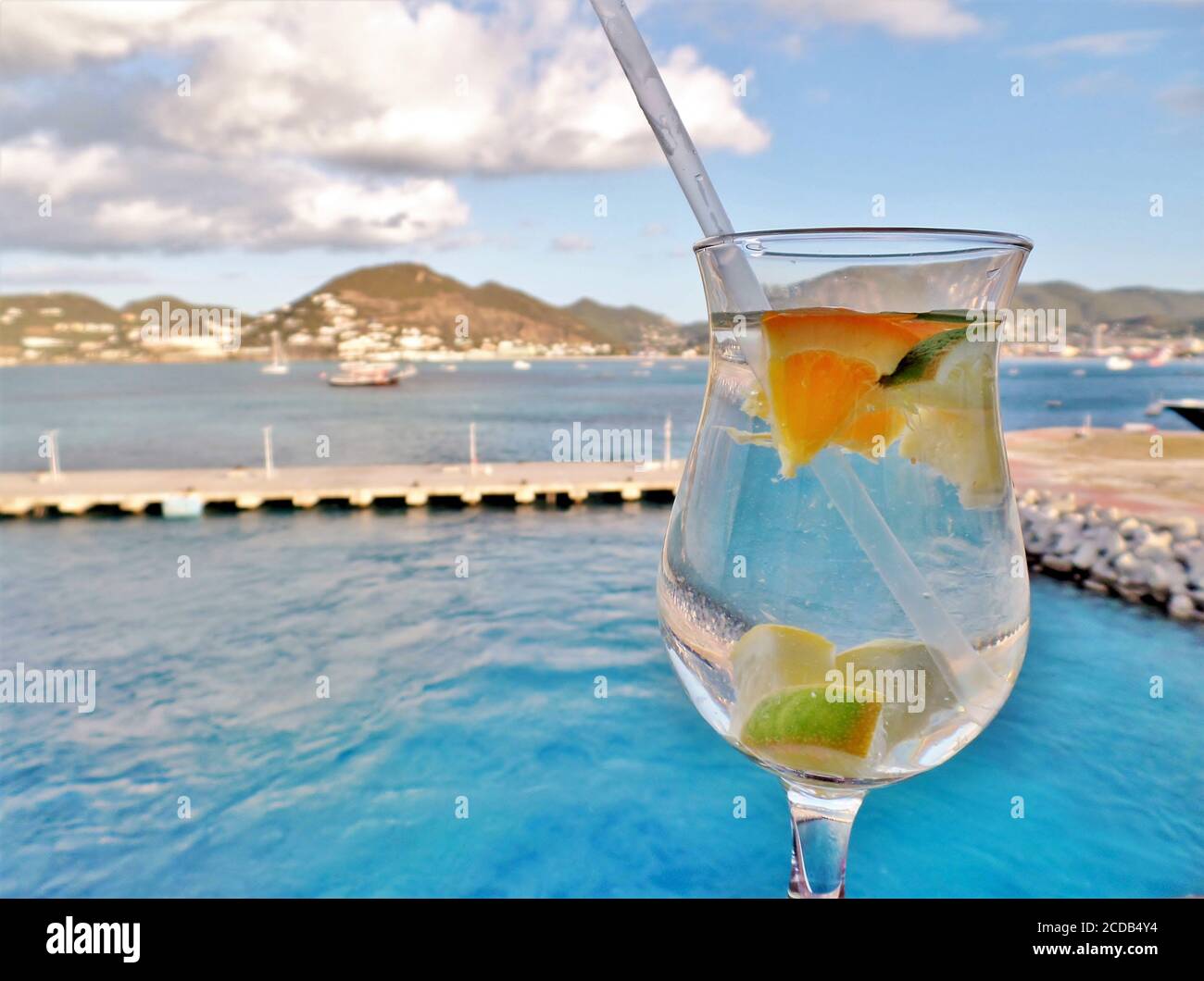 Glass of water with fresh lime and lemon slices sitting on a cruise ...